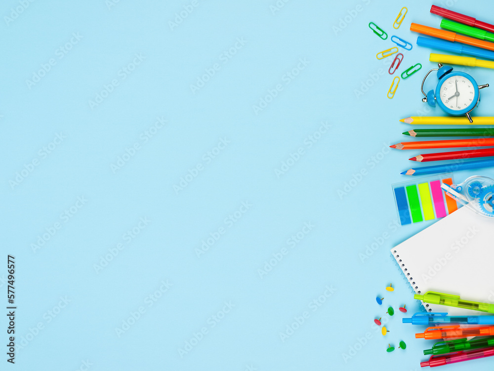 Variety of school supplies on blue background. Back to school concept ...