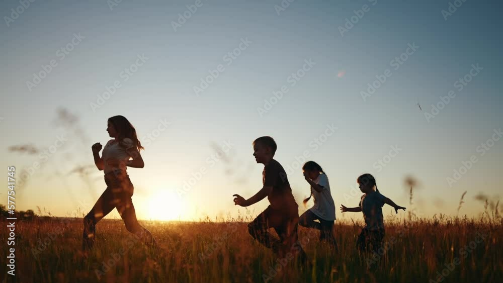 Children running in park at sunset. happy family kindergarten kids ...