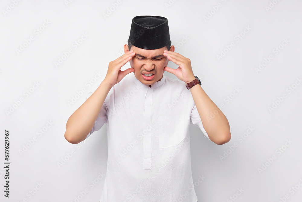 Unhealthy young Asian Muslim man wearing Arabic costume standing with ...