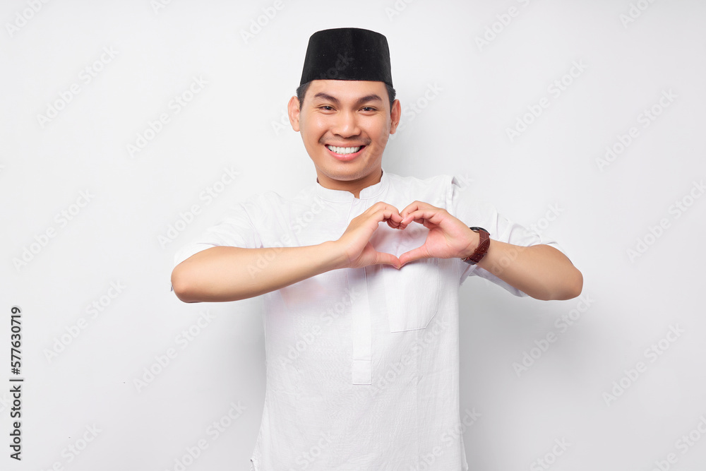 Smiling handsome young Asian Muslim man in Arabic costume standing with ...