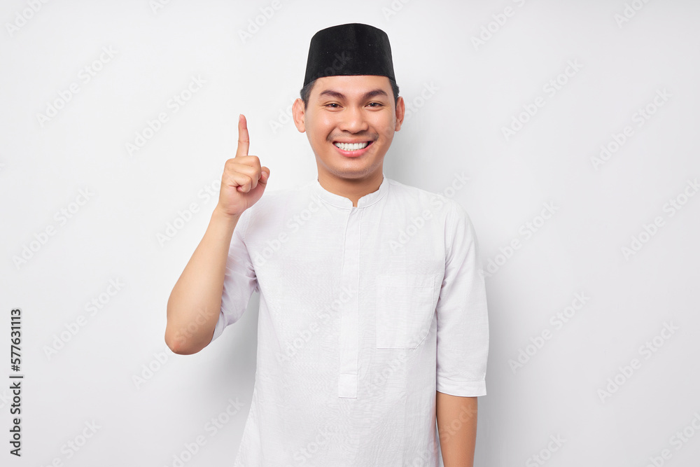 Cheerful Young Asian Muslim man in Arabic costume having creative idea ...
