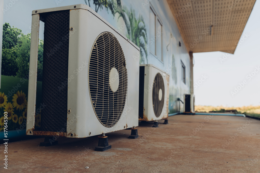 Air conditioner compressor installed in old building. Outdoor split ...