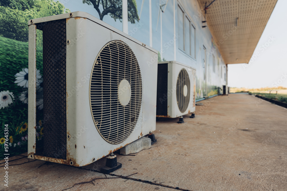 Air conditioner compressor installed in old building. Outdoor split ...
