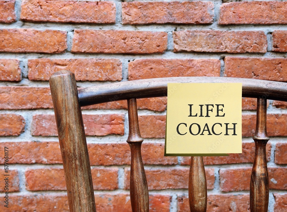 Wood chair with text label LIFE COACH, refers to those who ...