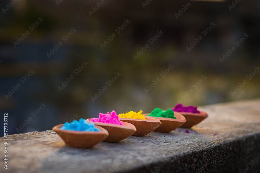 happy holi. gullal or abir, which are colorful powders for holi kept on ...