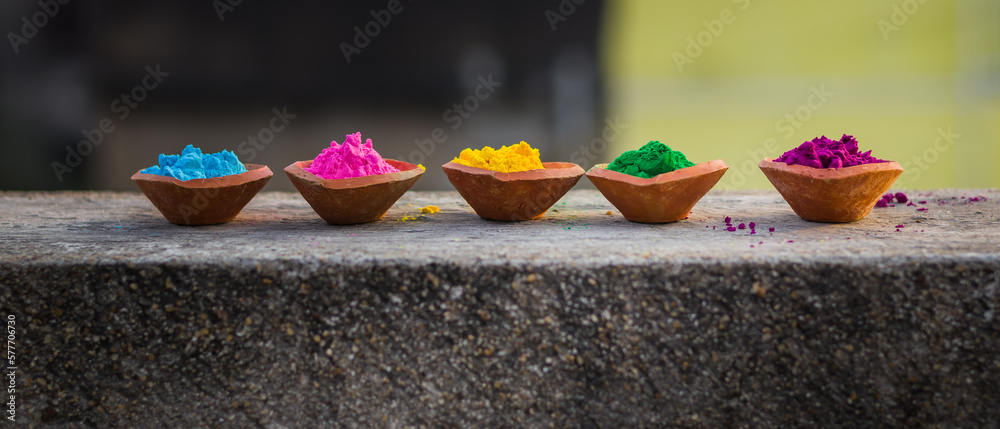 happy holi. gullal or abir, which are colorful powders for holi kept on ...