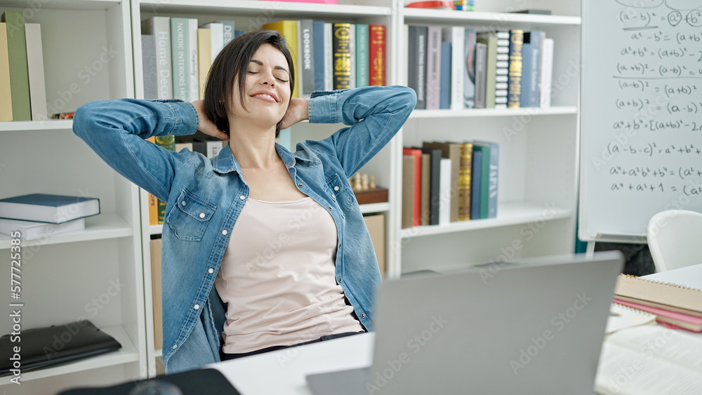Young caucasian woman student studying relaxed with hands on head at ...