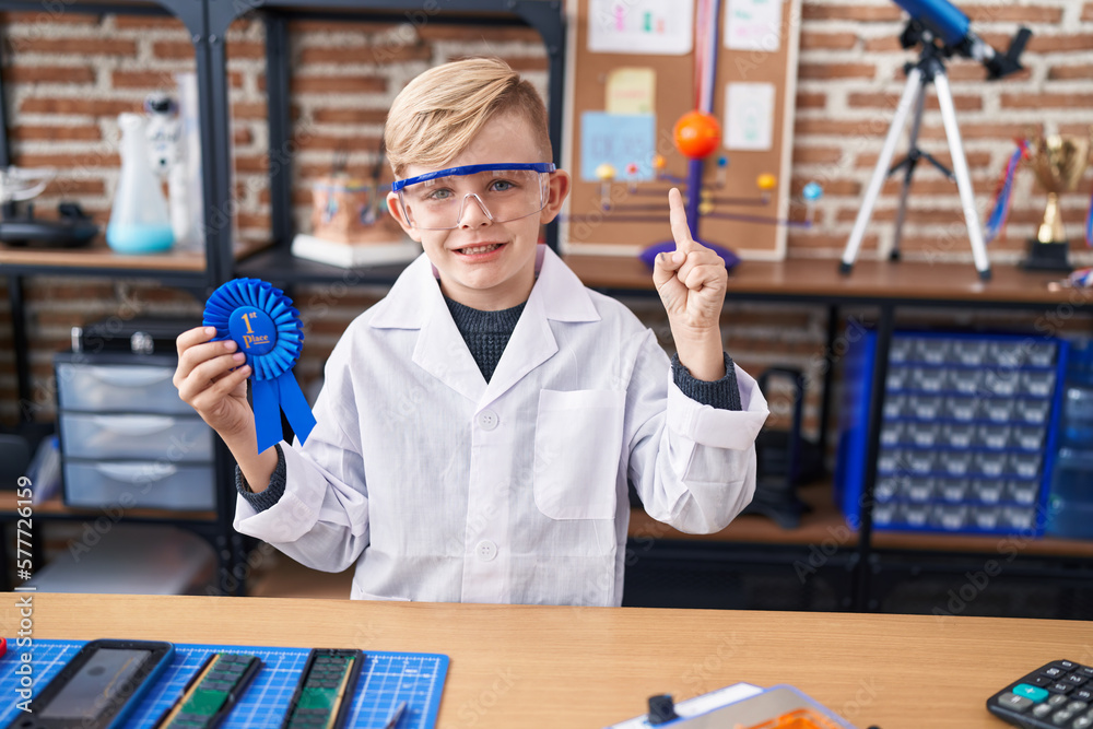 Little caucasian boy at school scientist laboratory winning first prize ...