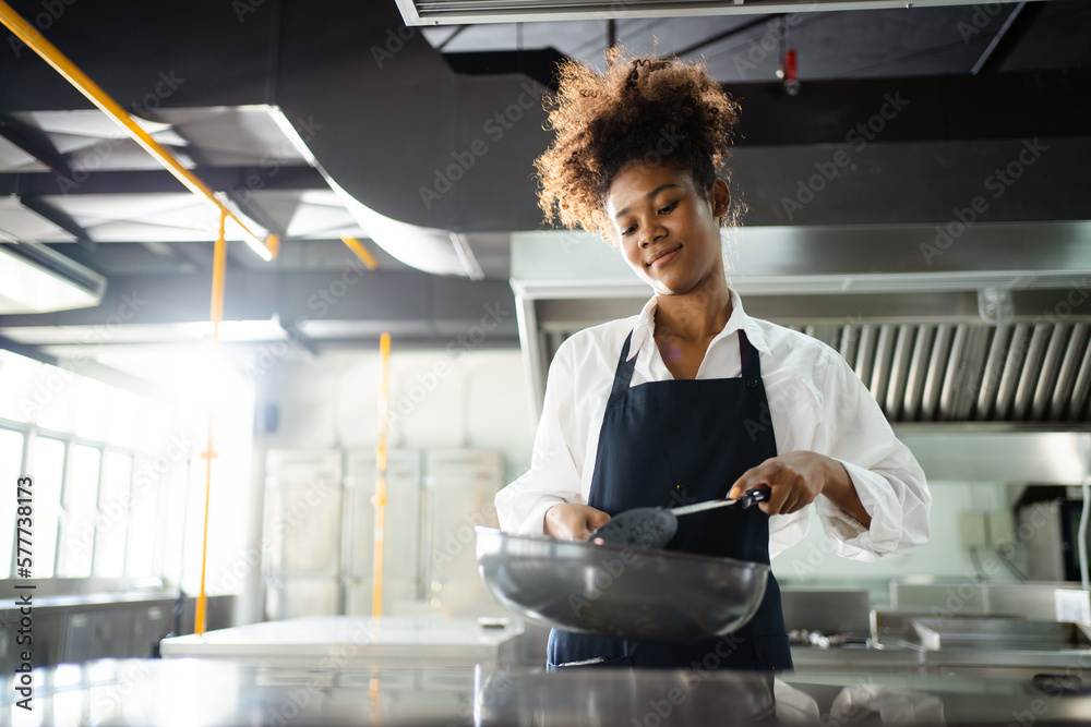 Foto de Happy African - black professional chef cooking in kitchen in ...