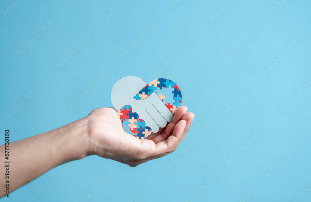 People hand holding jigsaw puzzle, Color puzzle symbol of awareness for ...