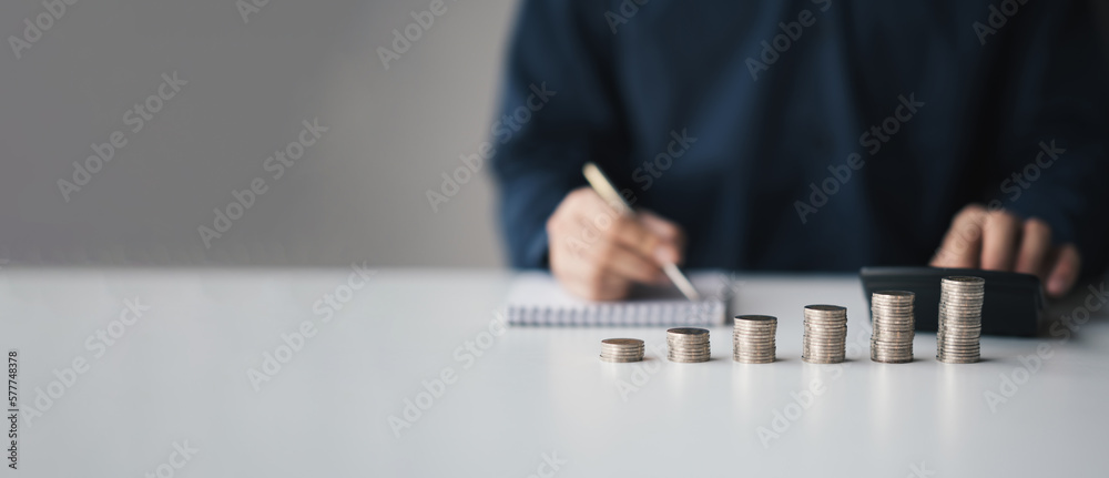 Money saving concept, accountant counting and calculating annual ...