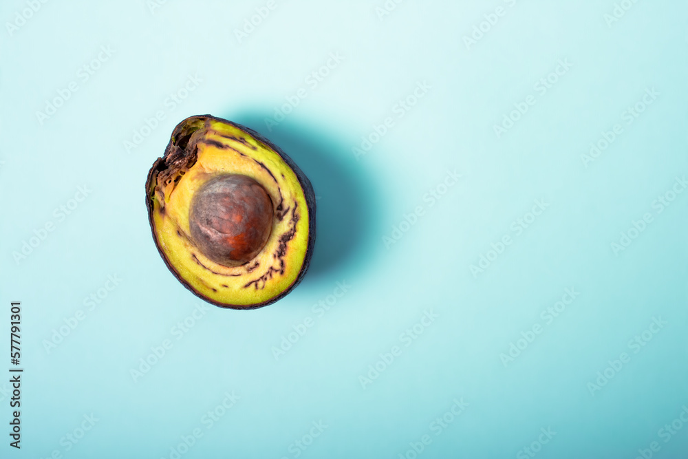 Rotten avocado, overriped, bad avocado. Half sliced fruit, freegan food ...