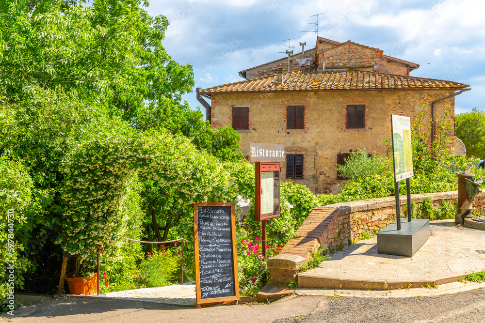 Street view of the plant covered arched arbor trellis at the entrance ...