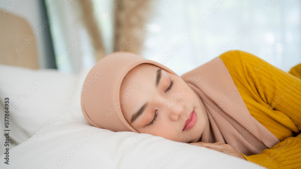 Sleeping young Muslim woman lying in bed with eyes closed. Attractive ...