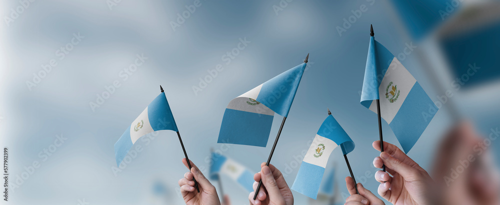 Photo & Art Print A group of people holding small flags of the ...