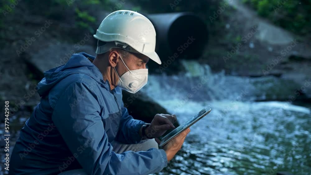 Engineer worker checking water quality of river. Wastewater treatment ...
