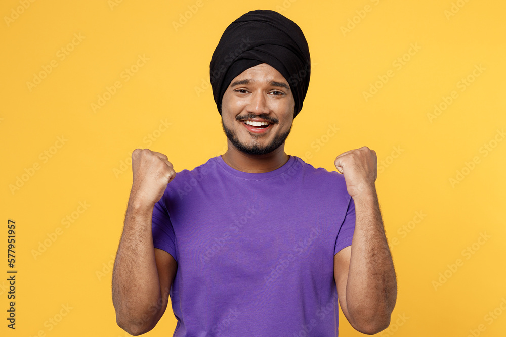 Devotee Sikh Indian man ties his traditional turban dastar wear purple ...