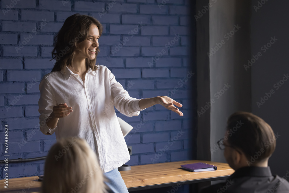 Cheerful positive mentor, business coach woman giving presentation ...