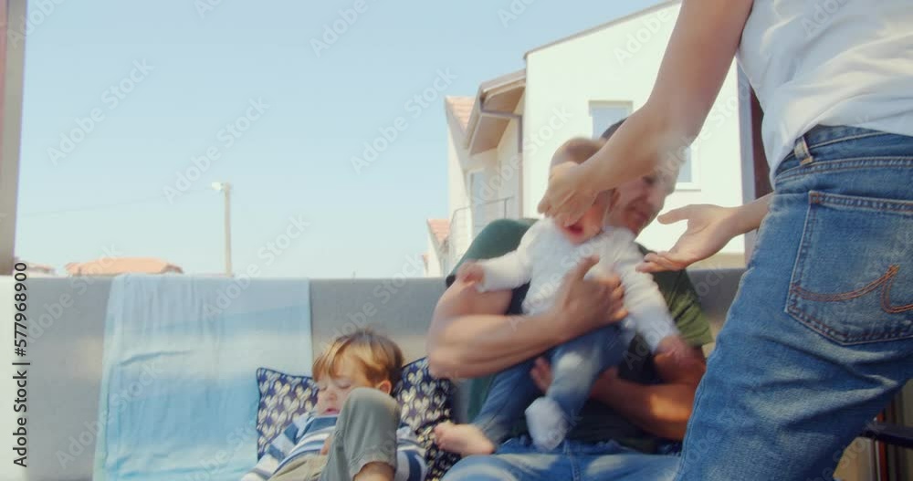Taking care of the baby while crying and handing her to her father ...