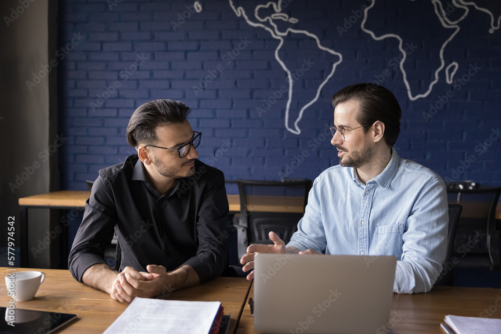 Handsome smart business professional men talking at workplace with ...