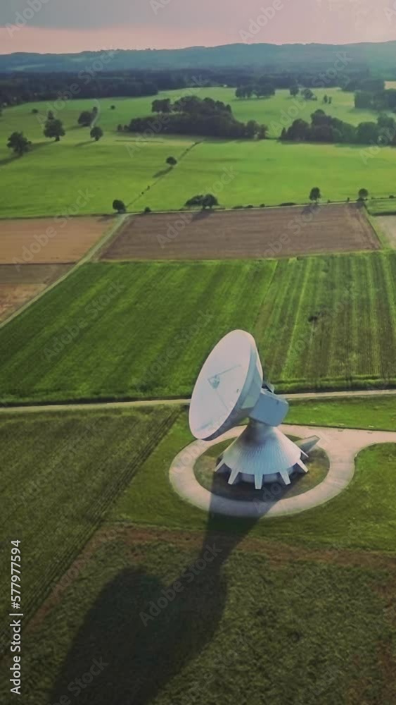 Satellite communication ground station in the middle of green fields ...