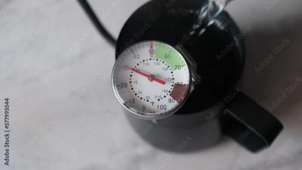 measuring the hot water in the container with a kitchen thermometer, 4k ...