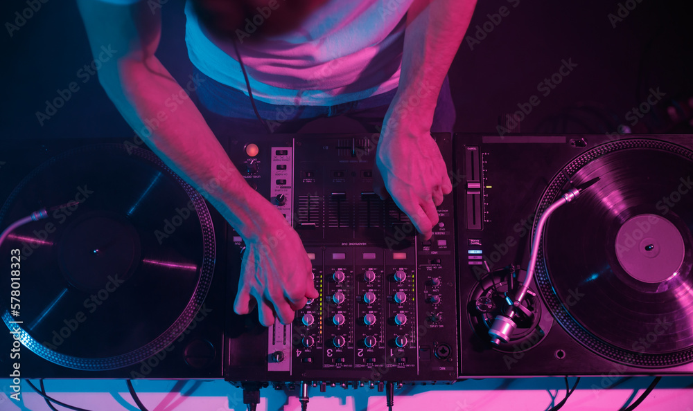 Overhead photo of disc jockey mixing records on party in night club ...
