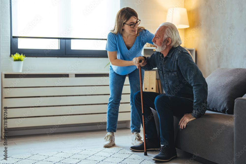 Young caring nurse helping senior old elderly man grandfather walk ...