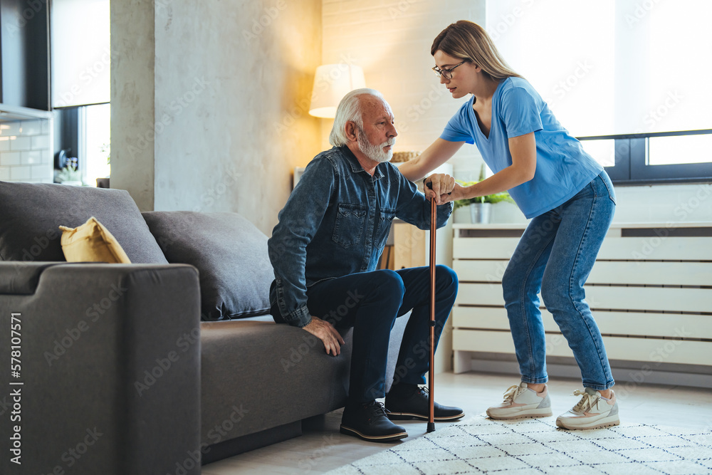 Young caring nurse helping senior old elderly man grandfather walk ...