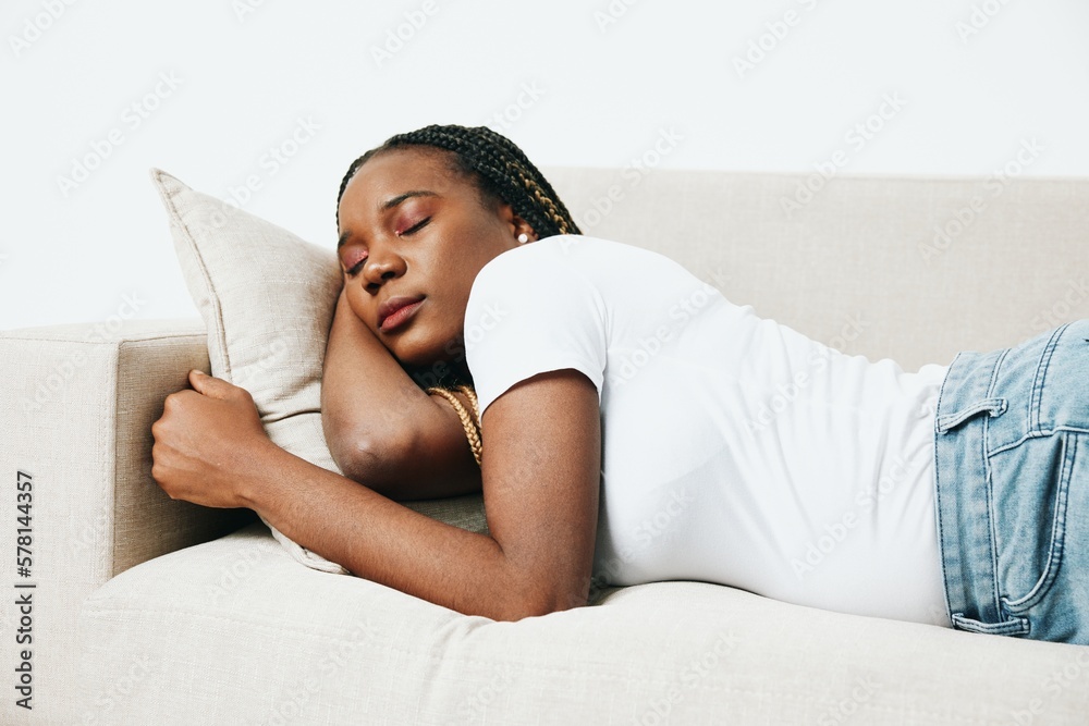 Happy african american woman sleeping at home on the sofa, rest and ...