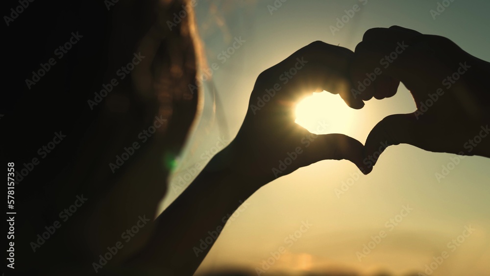 heart sign sunset background. beautiful girl with flowing hair against ...