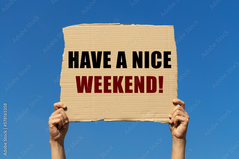 Have a nice weeked text on box paper held by 2 hands with isolated blue ...