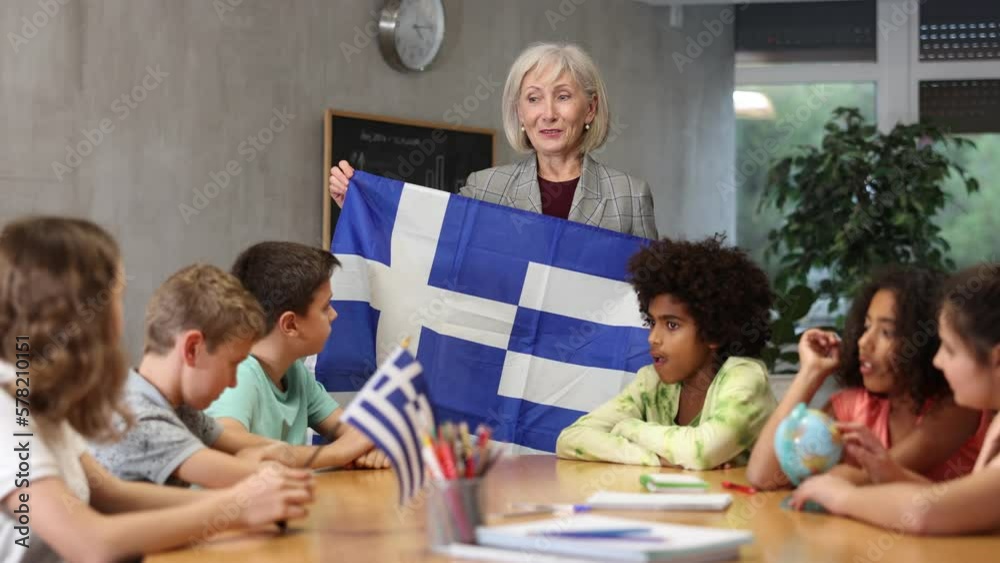 Kids learning together about greece in geography class Female teacher ...
