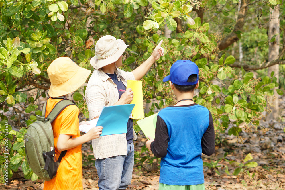 Asian man teacher is teaching botanical plants with students. Outdoor ...