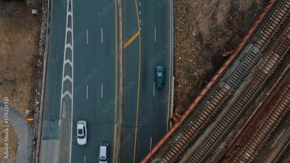 Hovering shots, static, of highway, cars and trains in New York City ...