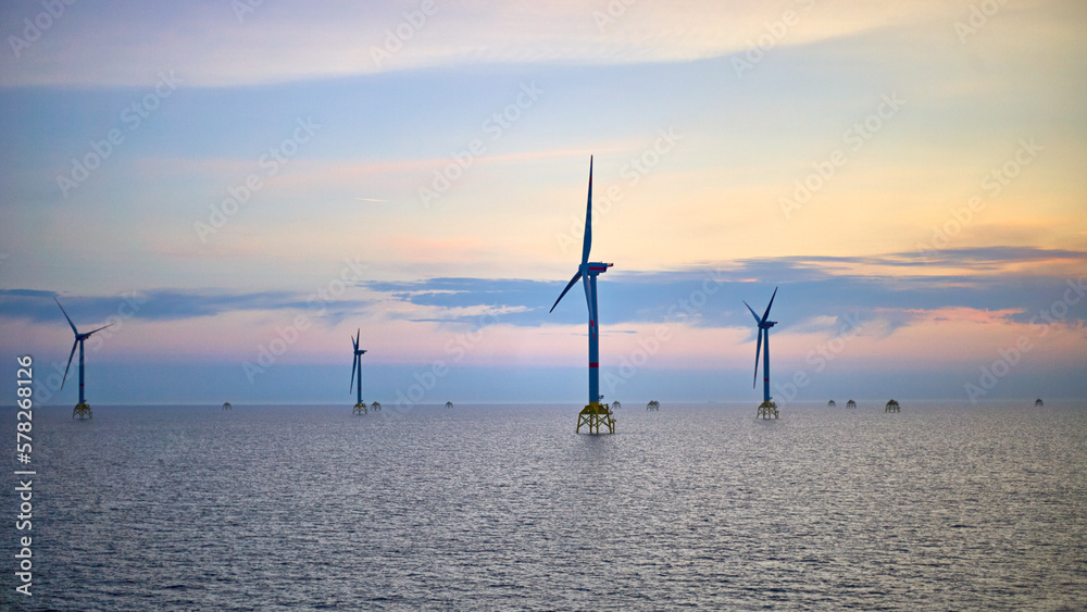 Electricity production by offshore wind turbine farm in the sea. Stock ...