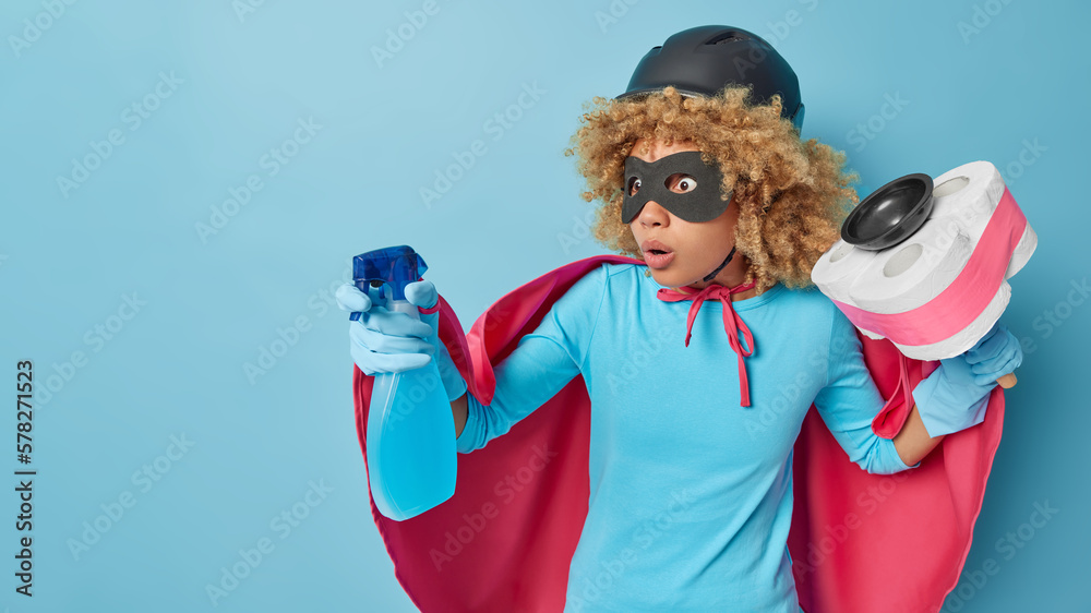 Scared frightened superwoman reacts to something astonishing poses with ...