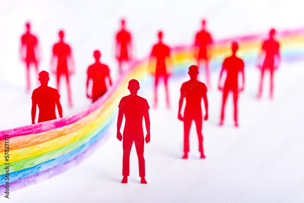 Paper cut-out figures standing around the hand painted lgbt colored ...