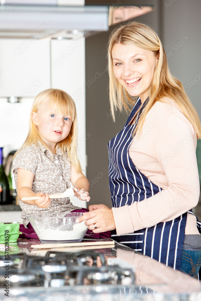 Family Life, Mixing the Cake. A young girl mixing a cake recipe while ...