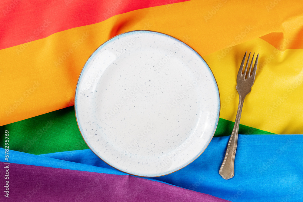 Gay dinner party invitation. A place at a restaurant table with a plate ...