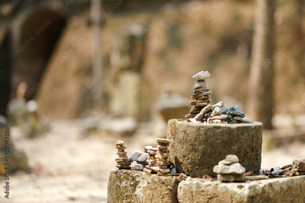 Stacking stones for meditation in front of old cave at Wat Umong Suan ...