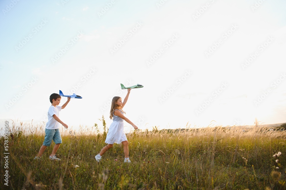 children play toy airplane. concept of happy childhood. children dream ...