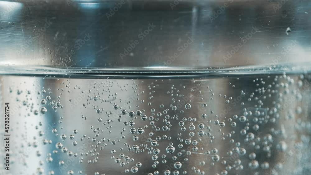 Glass water in side view with surface tension and fresh sparkling water ...