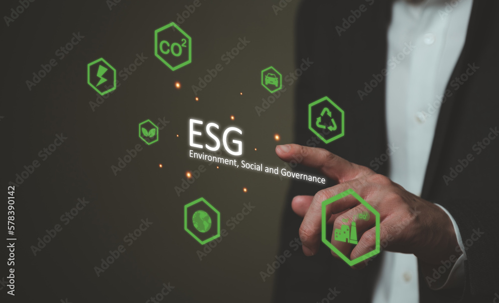 Entrepreneur hand point at ESG digital screen dashboard while control ...