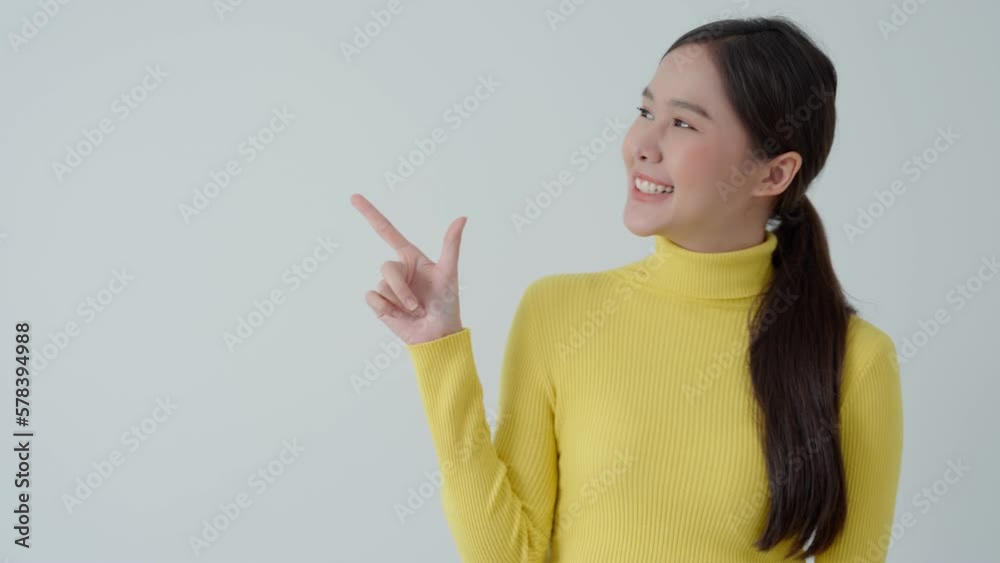 Portrait asian beautiful girl pointing blank space isolated background ...