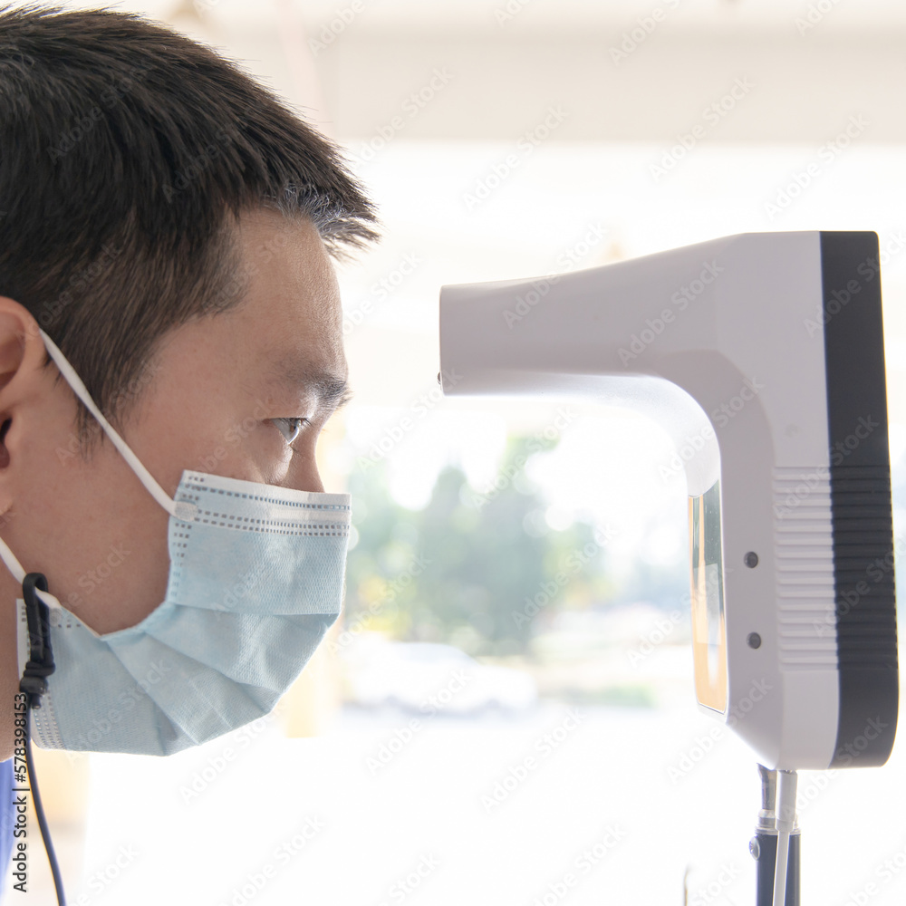 Fotka „Man approached the forehead thermometer sensor to detect body ...