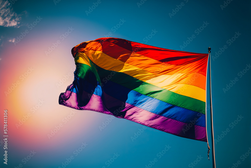 Rainbow flag proudly waving under a blue sky. A representation of the ...