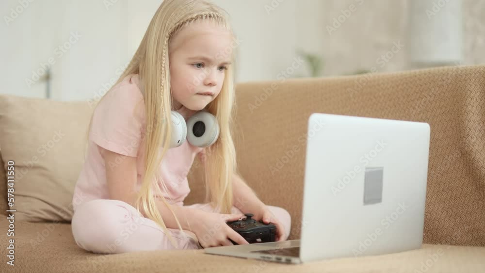 Excited cute blond little girl kid with joystick controller playing ...