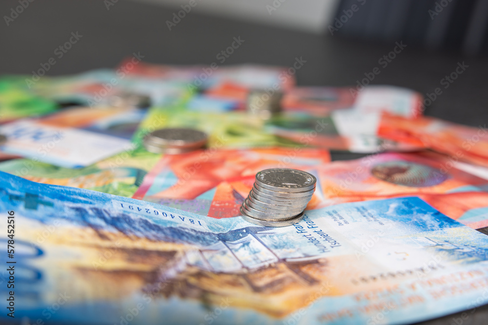 Swiss franc banknotes of various denominations, placed next to each ...