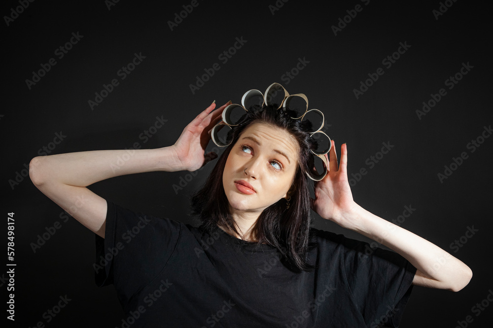 Portrait of a poor, skinny girl in black, rumpled clothes and a strange ...